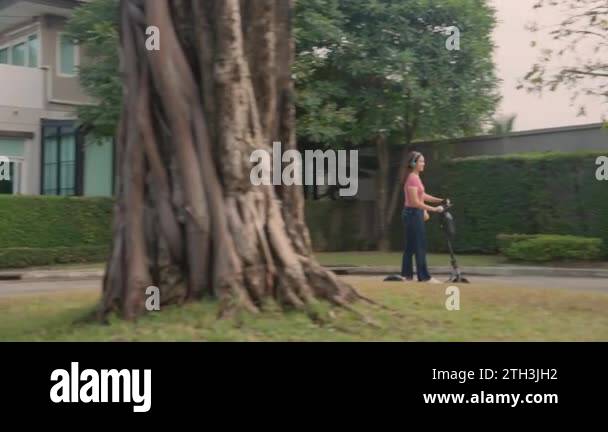 Young woman happy smile girl go green asia people ride EV bike push ...
