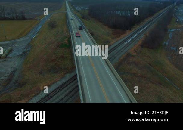 Cars, trucks and a bus traveling across an overpass running over ...
