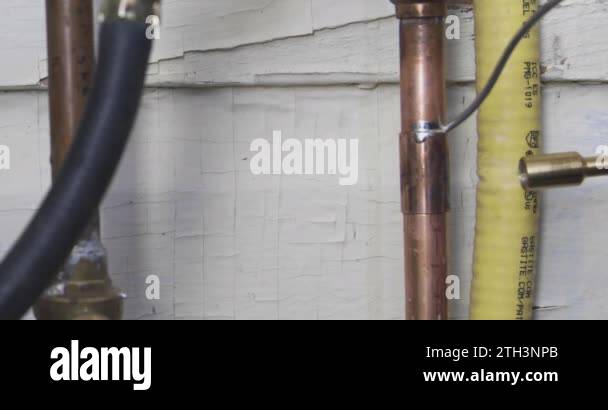 Welding the top and bottom of a copper pipe coupler using flux, solder ...