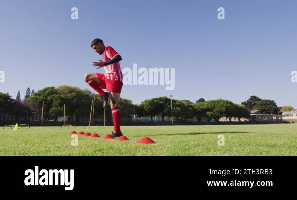 Video of diverse group of male football players warming up on field ...