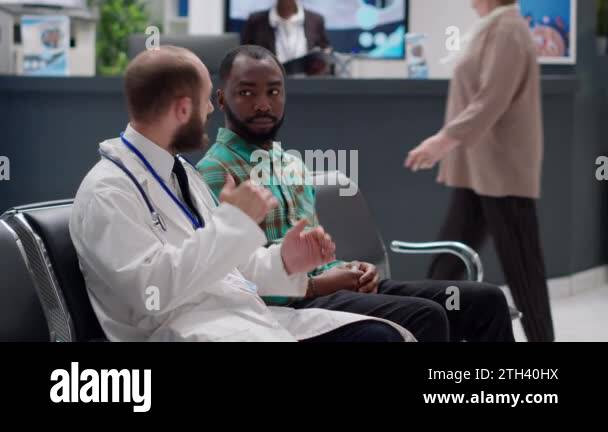 Diverse people doing consultation exam in hospital reception area ...
