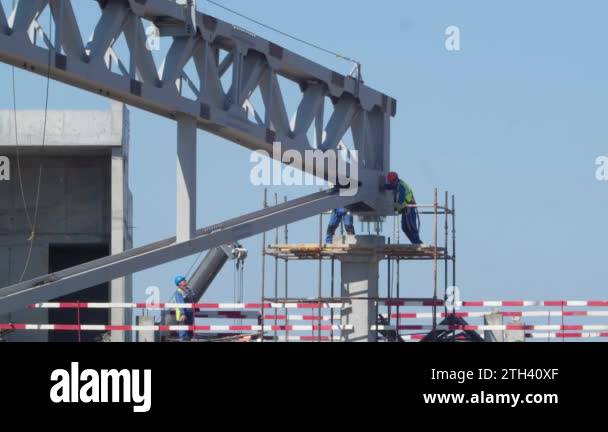 Builders push huge metal roof frame detail installing onto metal ...