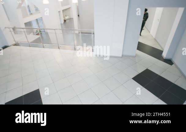 Business people walking at office building lobby. African American man ...