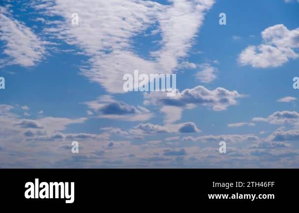 White clouds move and dissolve in the blue sky, Timelapse. Puffy fluffy ...