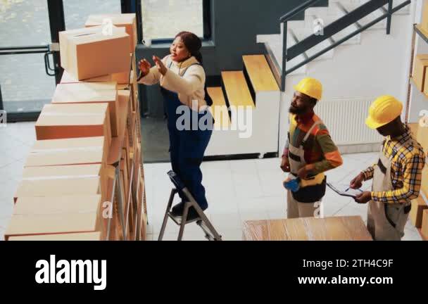 African american people organizing products in boxes, putting packages ...
