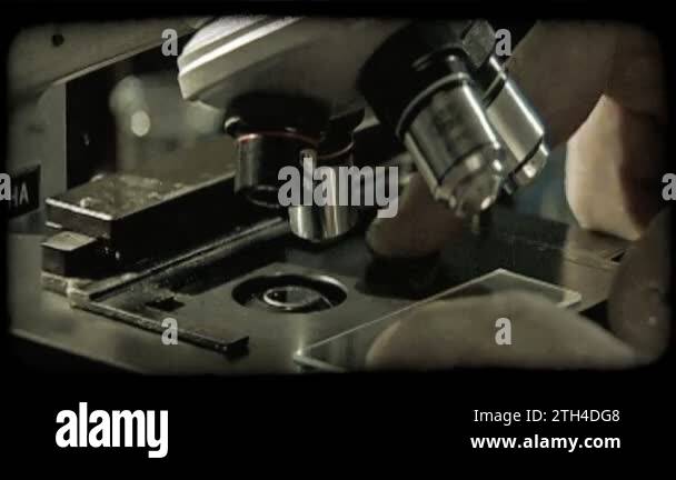 Close up of hand positioning plastic examination plate with drop of ...