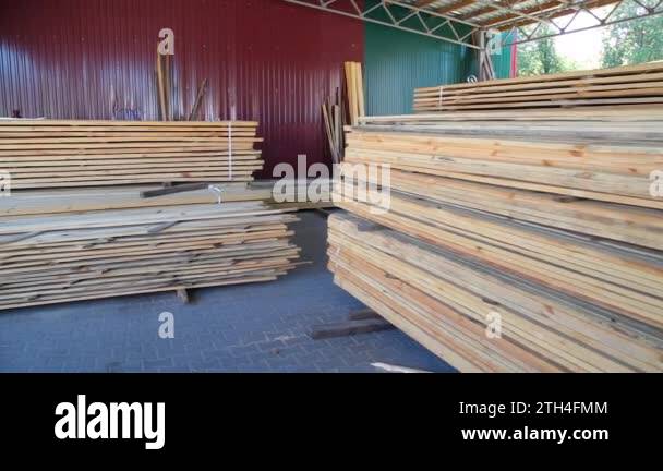 Wood warehouse. Sliced wooden boards are stored in a trading warehouse ...