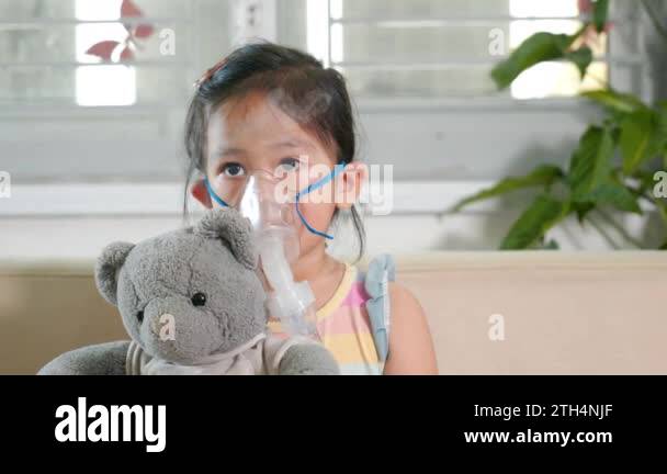 Kid girl making makes inhalation nebulizer steam sick cough at home ...
