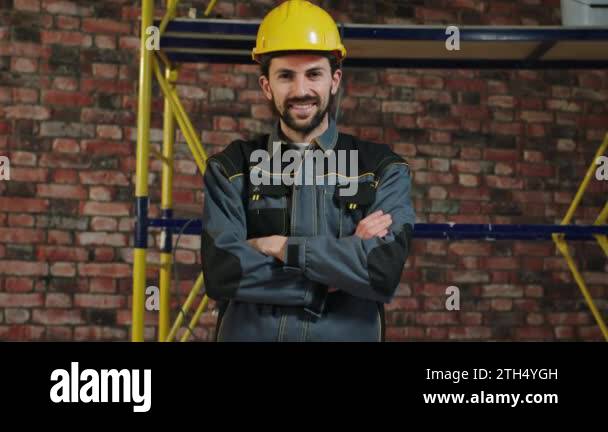 Charismatic with a large smile constructor worker posing in front of ...
