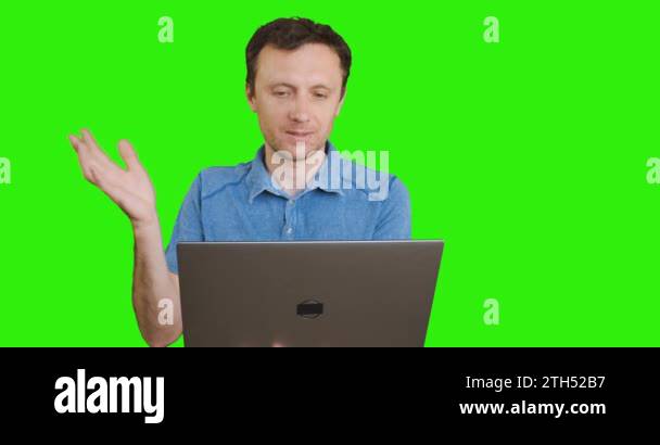 Young man ends video call through computer. He waves his hand, closes ...