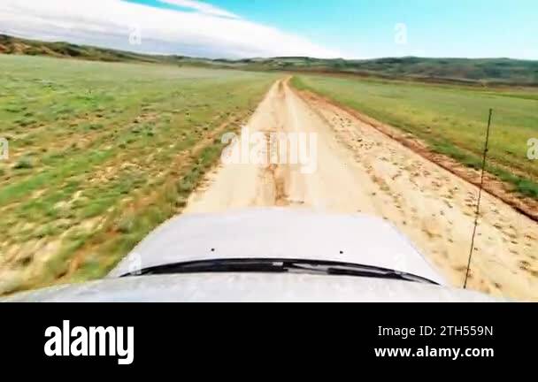 First person view front side 4WD vehicle drives real time on gravel ...