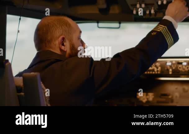Airline captain using control panel buttons command to fly plane from ...