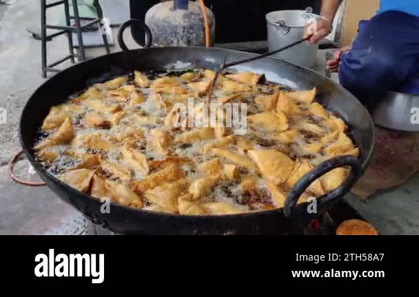 Footage of boiling hot Samosas in a frying utensil. Delicious Indian ...