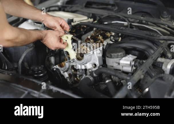 Unrecognizable mechanic repairing automobile motor using tool. Car ...