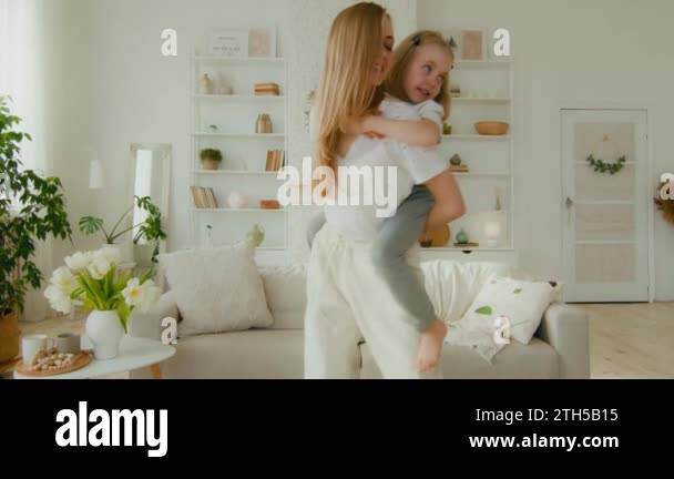 Caucasian mother babysitter woman holding little cute girl daughter ...