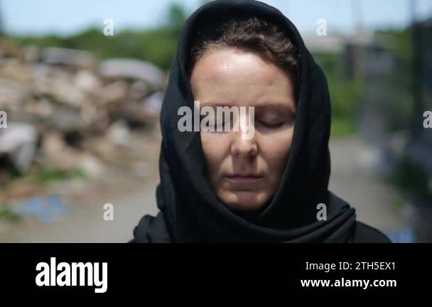 The face of a woman left a widow close-up. She stands against the ...