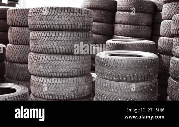Tire stack background. car tires stacked one on top of another in a warehouse Stock Video ...