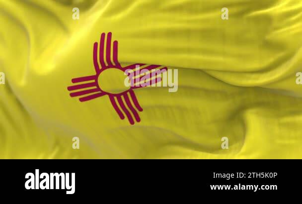 Detail of the New Mexico state flag waving. Red sun, symbol of the Zia ...