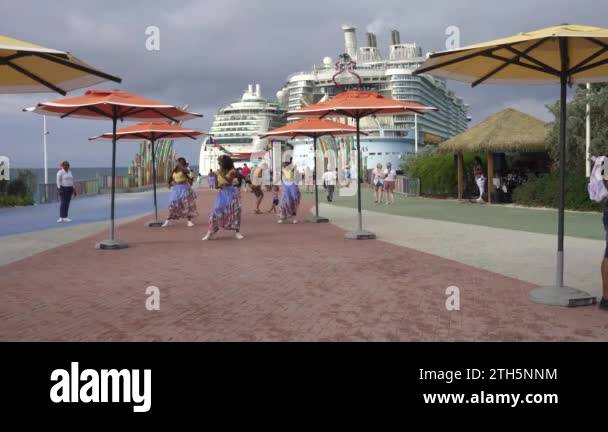 Coco Cay, Bahamas: Caribbean dancers while cruise passengers walking ...