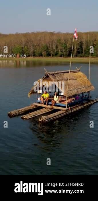 Couple of men and women at a bamboo raft at Huai Krathing lake in North ...