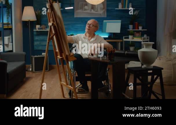 Retired adult living with disability and drawing sketch on canvas ...