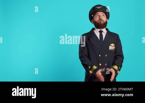 Spiritual aircrew captain praying to god in studio, being religious and ...
