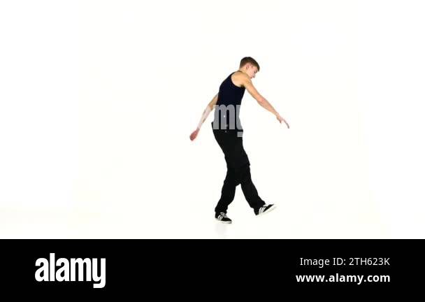 Modern blonde dancer in black suit continue dancing breakdance on white ...