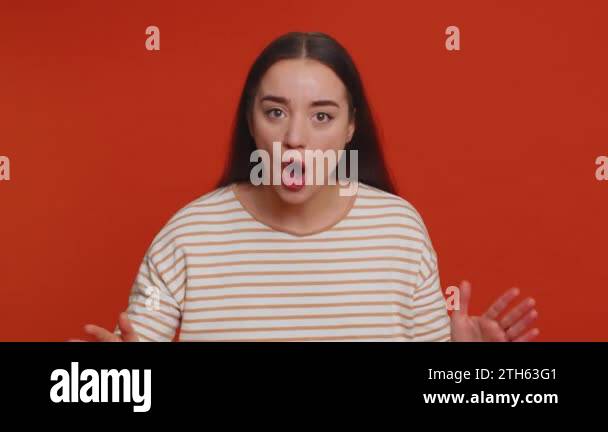 Quarrel. Displeased pretty young woman gesturing hands with irritation ...