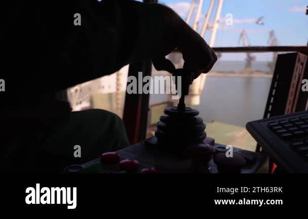 Man hands control joysticks at grain terminal operator cabin workplace ...