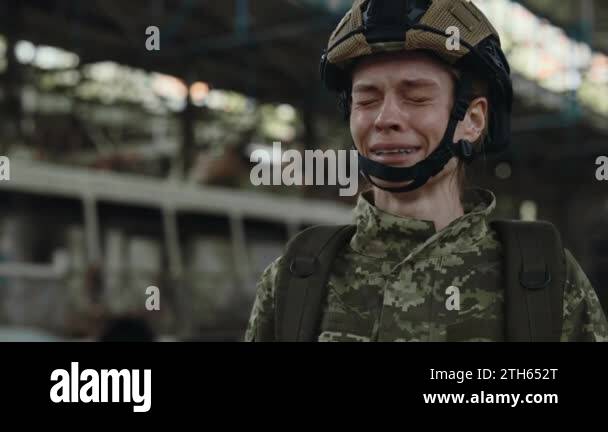 Military woman soldier in uniform and helmet crying while having hard ...