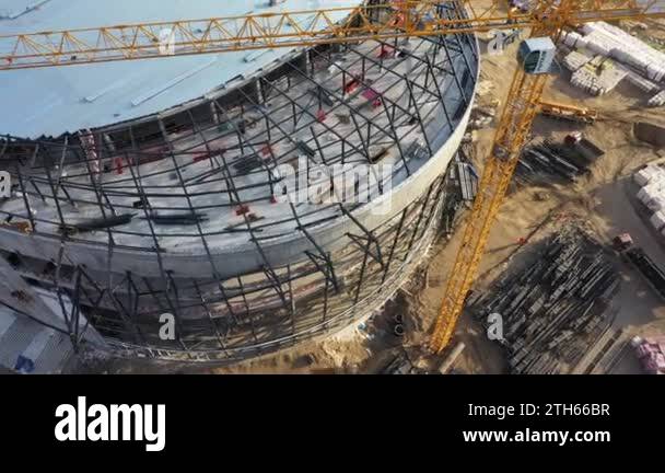 Roofing sports arena building with metal frame and powerful tower crane ...