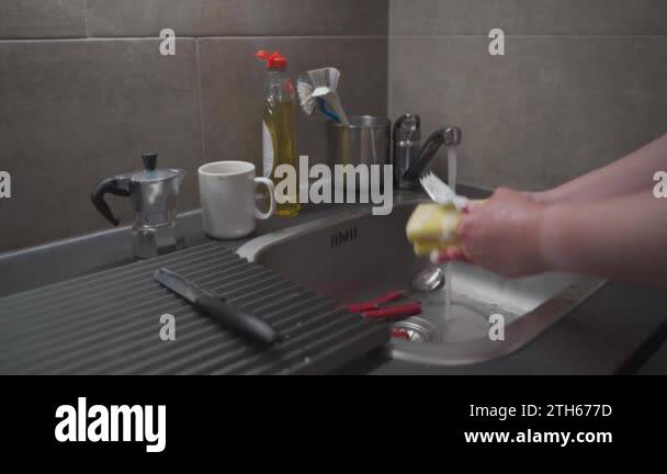 House cleaning, household chores. Washing dishes and kitchen utensils ...