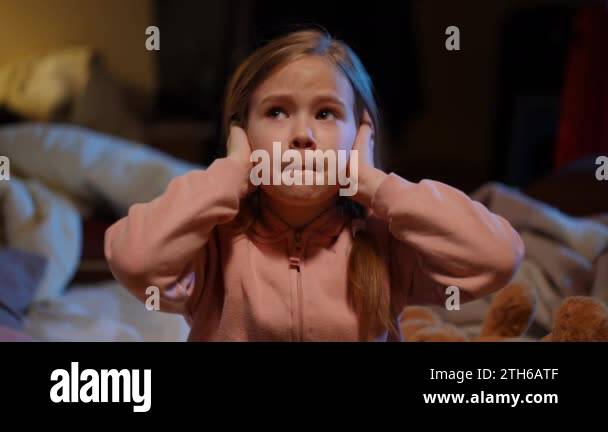 Scared stressed anxious Ukrainian girl covering ears with hands ...