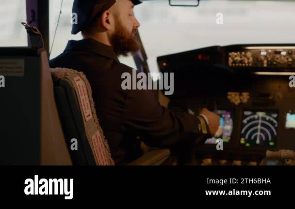 Portrait of airline captain sitting in pilot seat to fly airplane using ...
