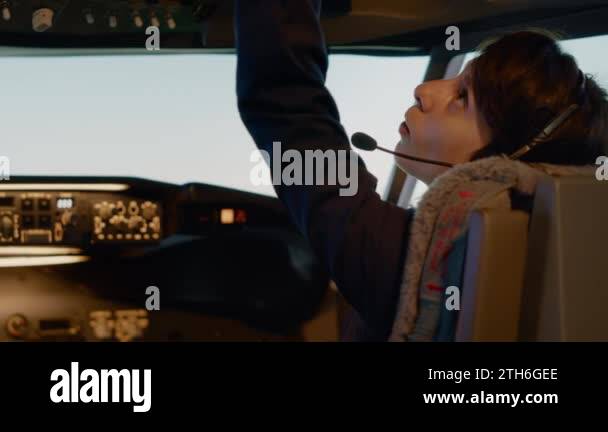 Female copilot pushing dashboard buttons to start engine and fly ...