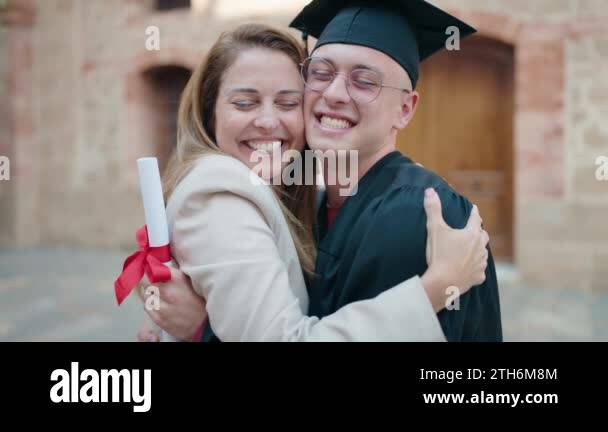 Man And Woman Mother And Son Hugging Each Other Celebrating Graduation