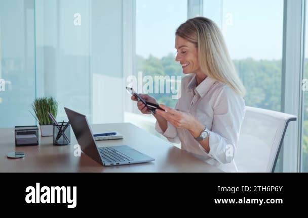 Glad happy business woman holding credit card using instant mobile ...