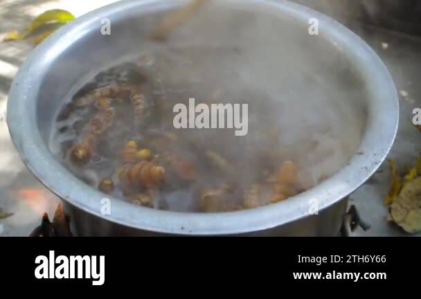 A close up shot of turmeric root being boiled in a big pot . Turmeric ...