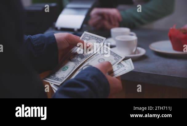 Cash payment in a restaurant. Customer pays by cash in a cafe. Buying ...