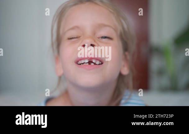 Happy child smiles with his teeth at camera. Cute little girl in bright ...