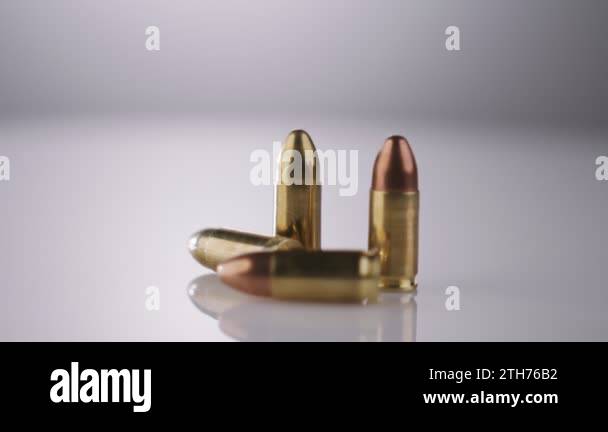 9mm gun rotating on a reflective surface Stock Video Footage - Alamy
