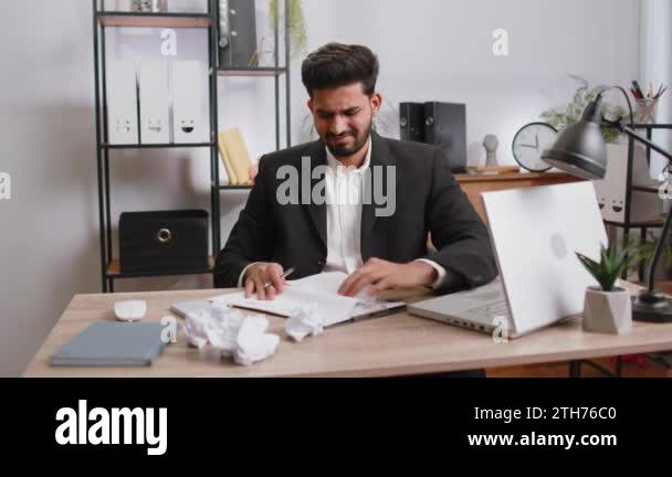 Angry furious indian man working at office throwing crumpled paper ...