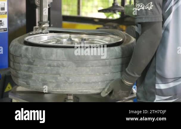 Repairman replace tire. Auto removal mechanic equipment loading ...