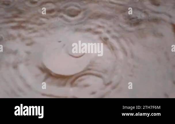 Drops of rain water falling on the ceramic floor tile of the terrace in ...