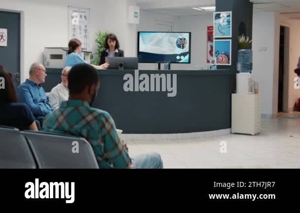 Busy hospital reception with diverse group of patients in waiting room ...