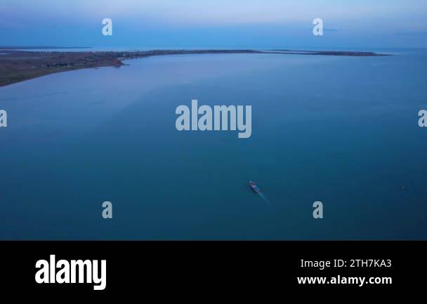The embankment of the city of Balkhash. A ship is sailing on the lake ...