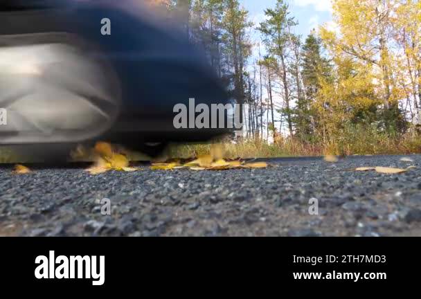 Ground level perspective of car driving over a asphalt road during ...
