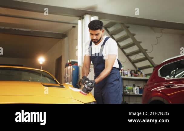 Full length portrait of young handsome man, worker of auto detailing ...