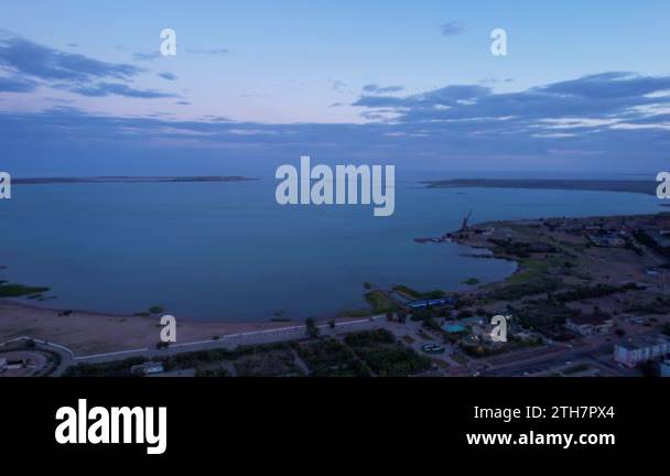 The embankment of the city of Balkhash. A ship is sailing on the lake ...