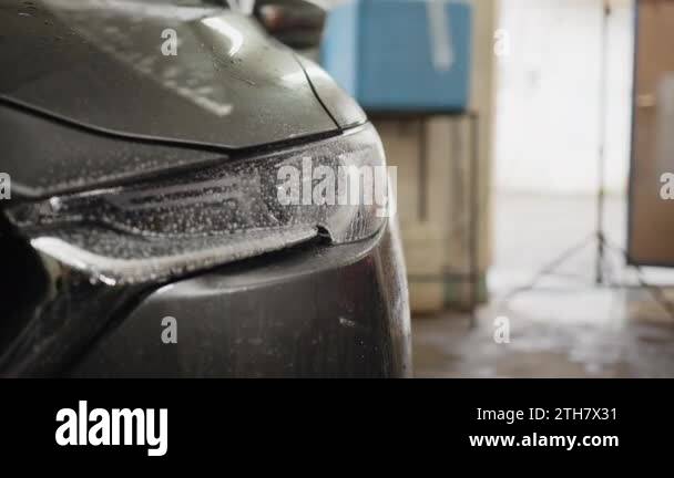 Close up to PPF installation process on a front headlight . PPF is a ...